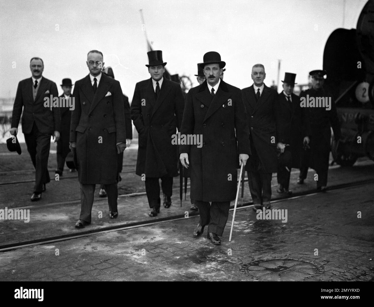 King Boris of Bulgaria, in foreground wearing bowler hat, walking along ...