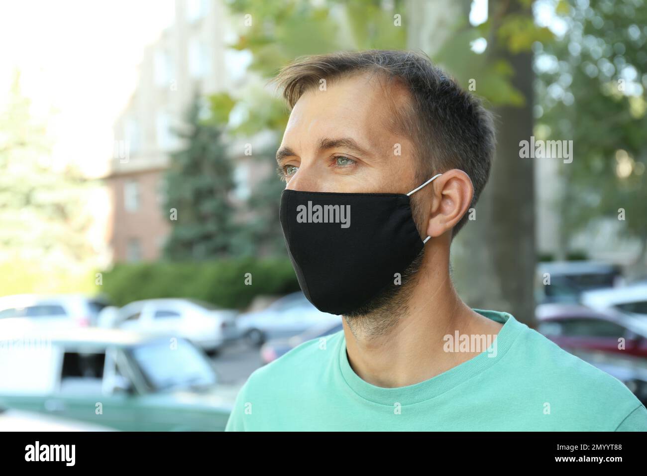 Man wearing handmade cloth mask outdoors. Personal protective equipment ...