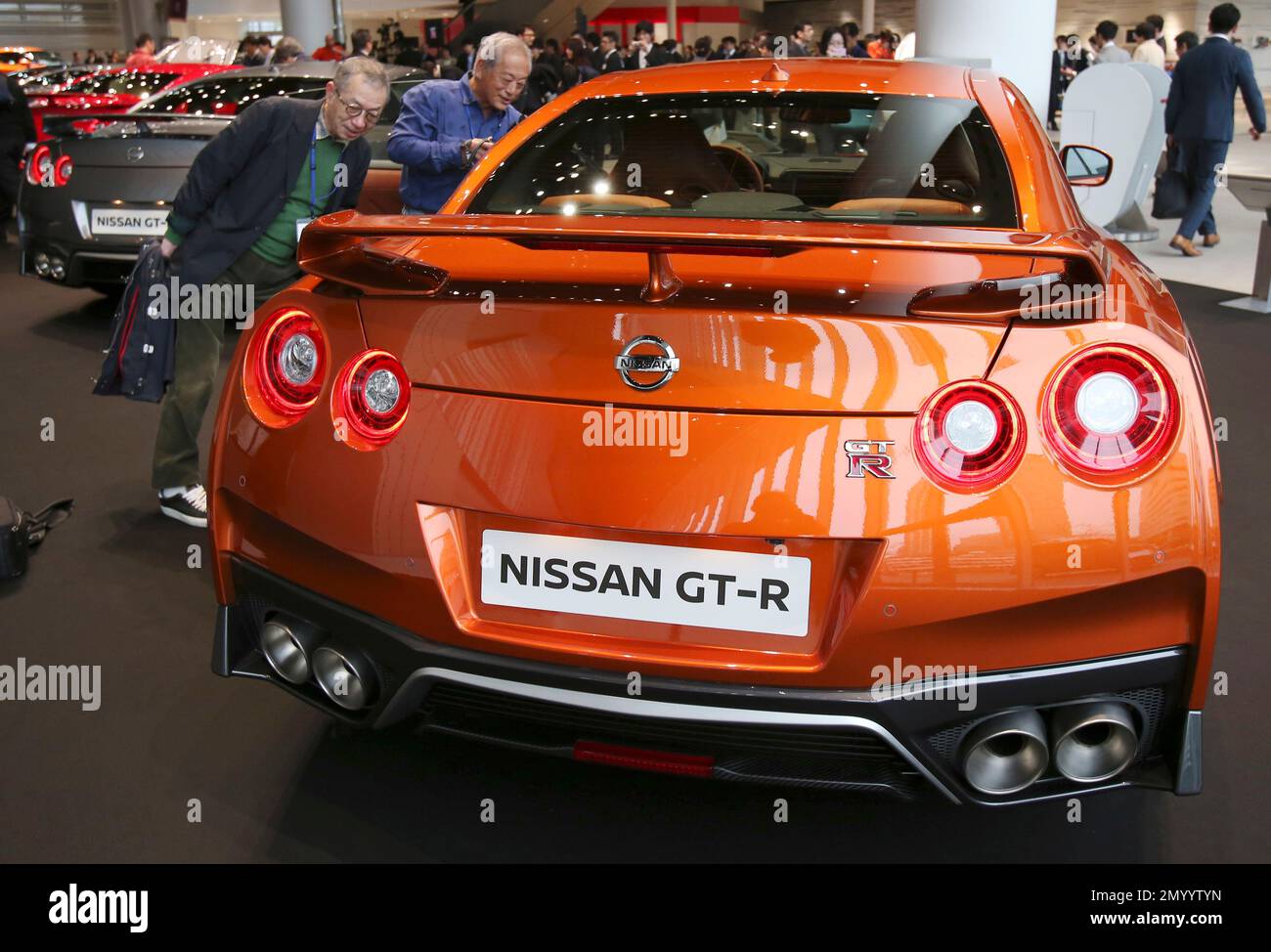 Visitors look at a new 2017 Nissan GT-R model unveiled by the Nissan ...