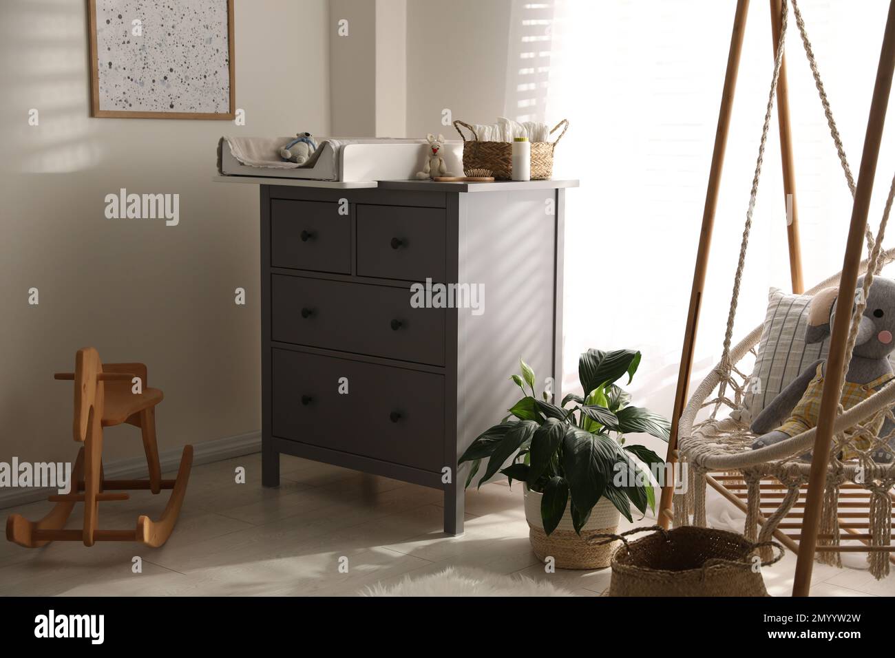 Baby room interior with modern changing table and wooden swing Stock ...