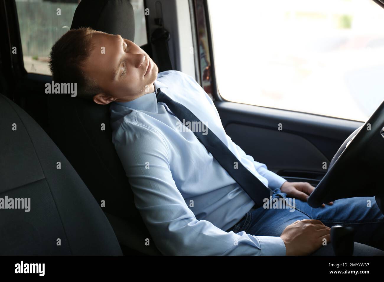 Tired young businessman steering hi-res stock photography and images ...