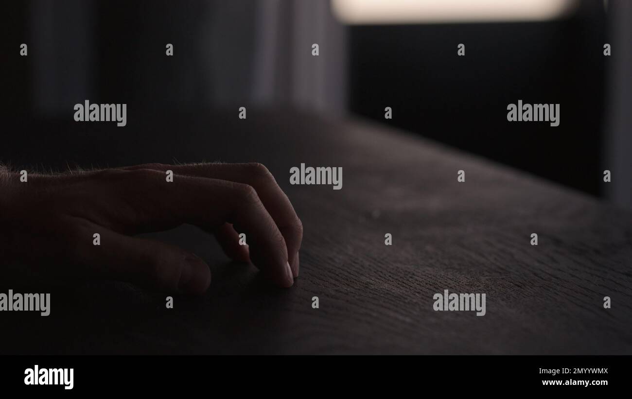 man hand finger tapping on black oak table with copy space, wide photo ...