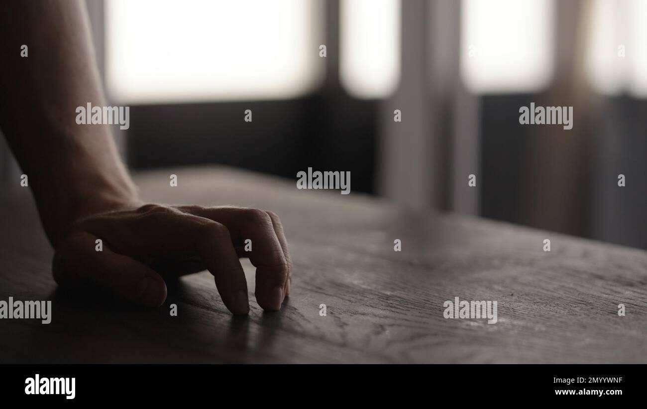 man hand finger tapping on black oak table with copy space, wide photo ...