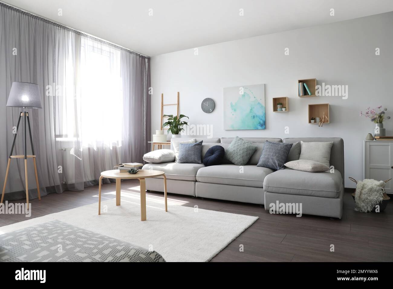 Elegant living room with comfortable sofa near window. Interior design ...