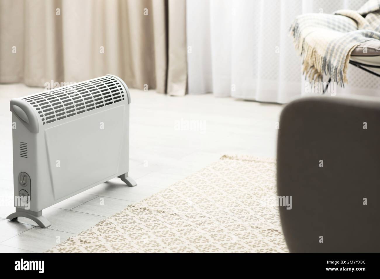 Modern electric heater in stylish room interior Stock Photo - Alamy