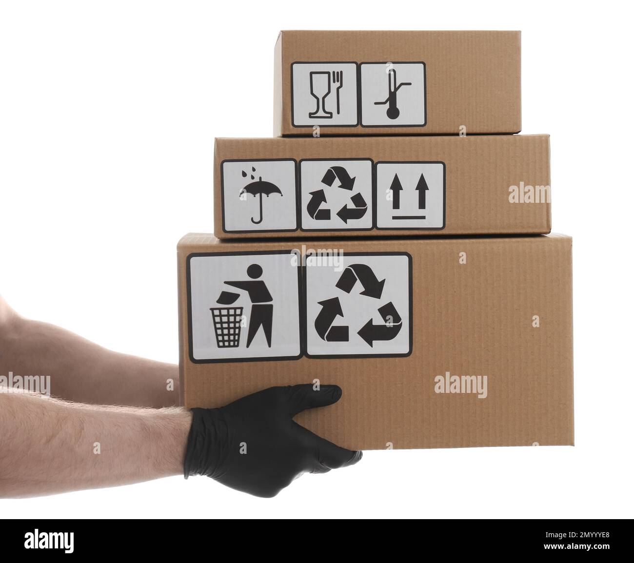Courier holding cardboard boxes with different packaging symbols on ...