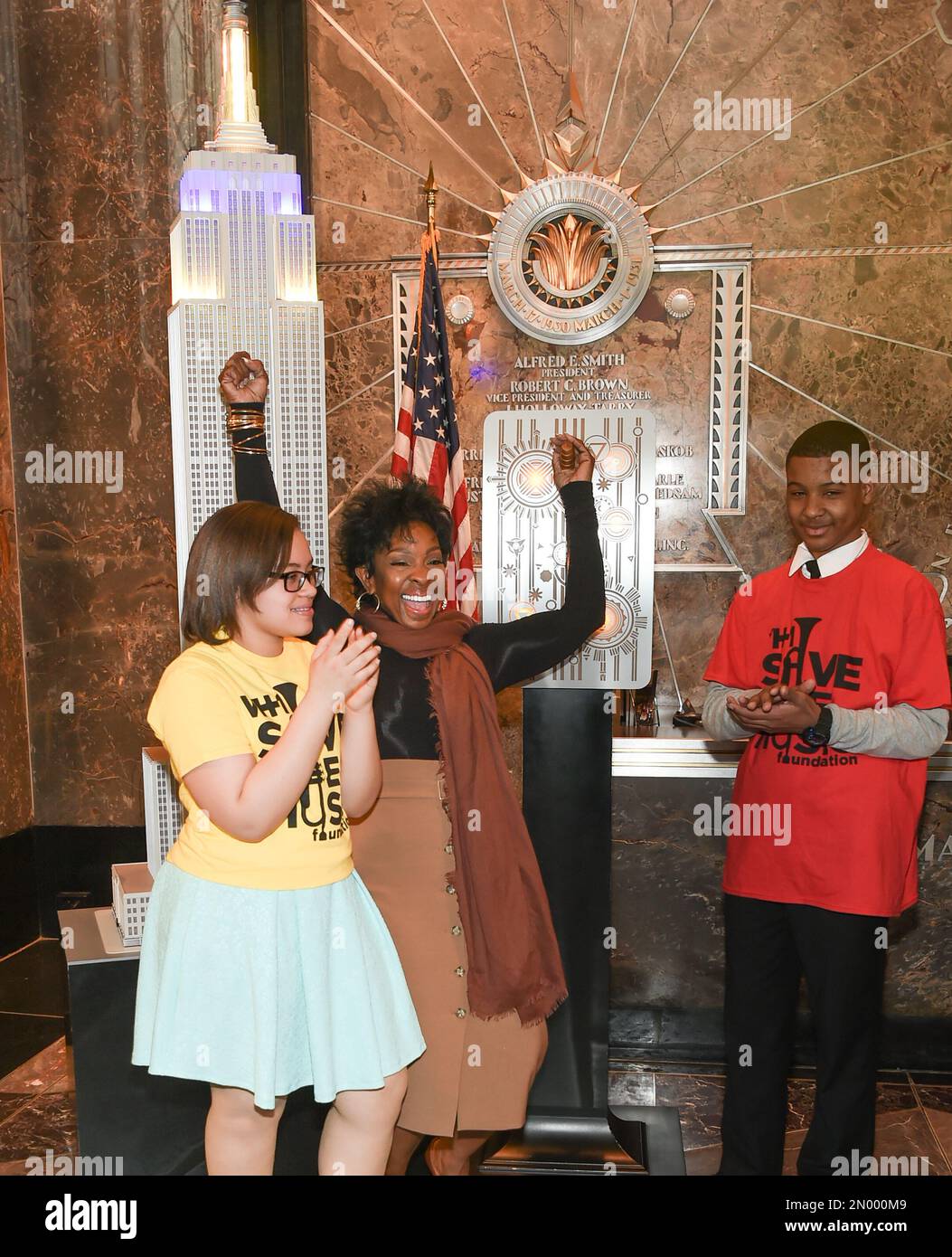 Singer Gladys Knight, center, lights the Empire State Building with ...