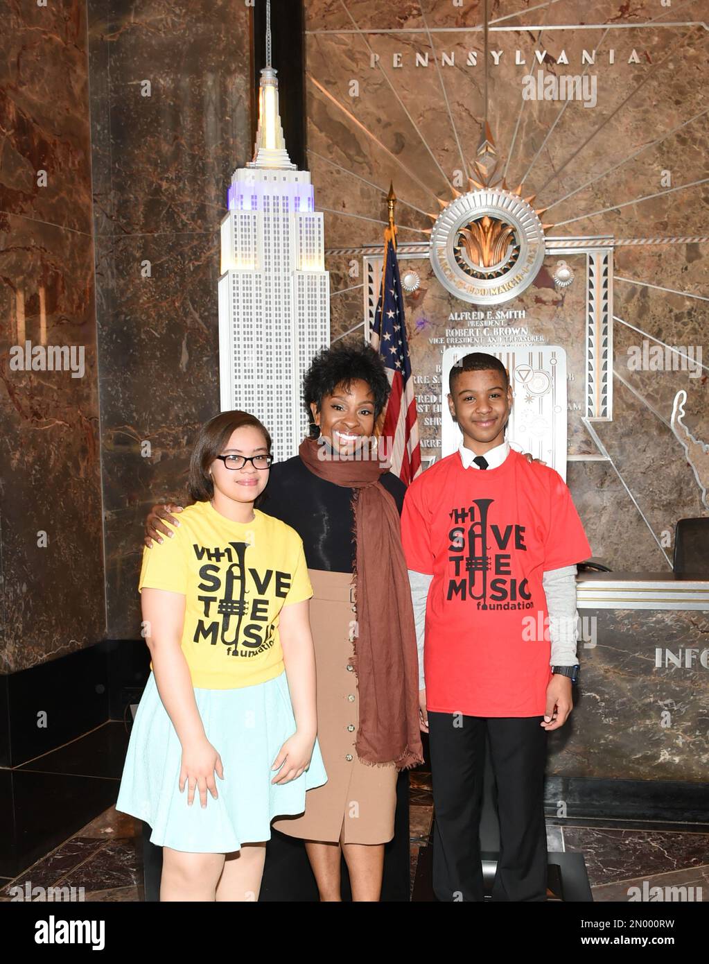 Singer Gladys Knight, center, lights the Empire State Building with ...