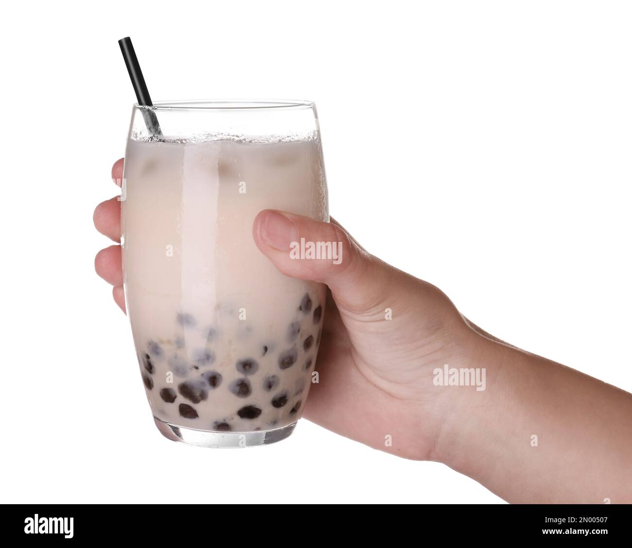 Woman holding glass of bubble milk tea with tapioca balls on white ...