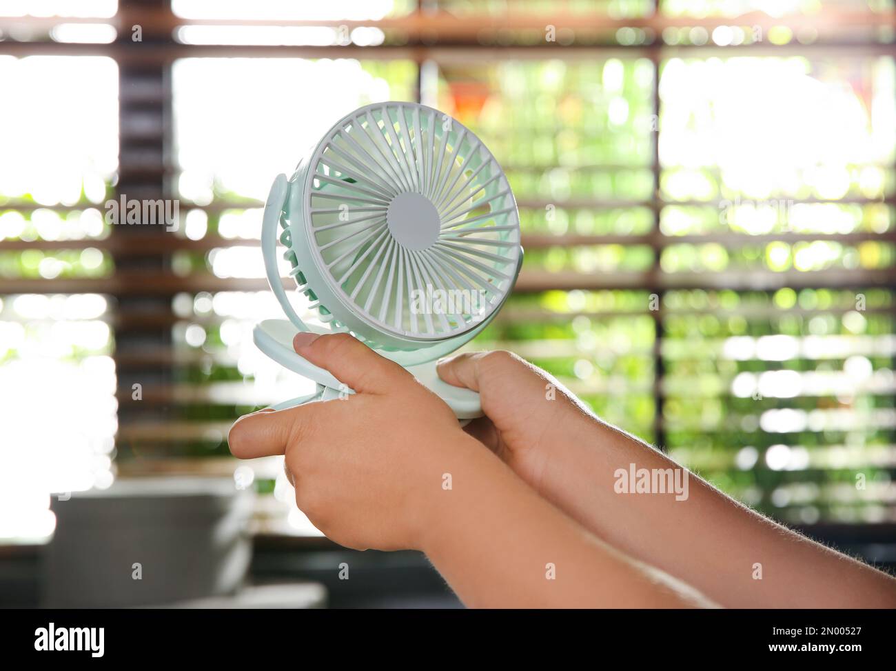 Little child with portable fan at home, closeup. Summer heat Stock ...