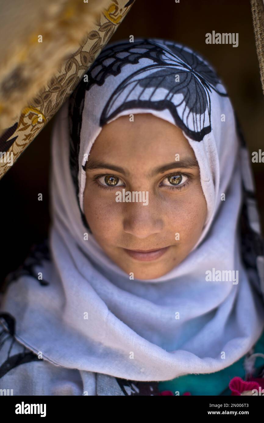 Syrian refugee Halima Ahmad, 11, poses for a picture at the doorway of ...
