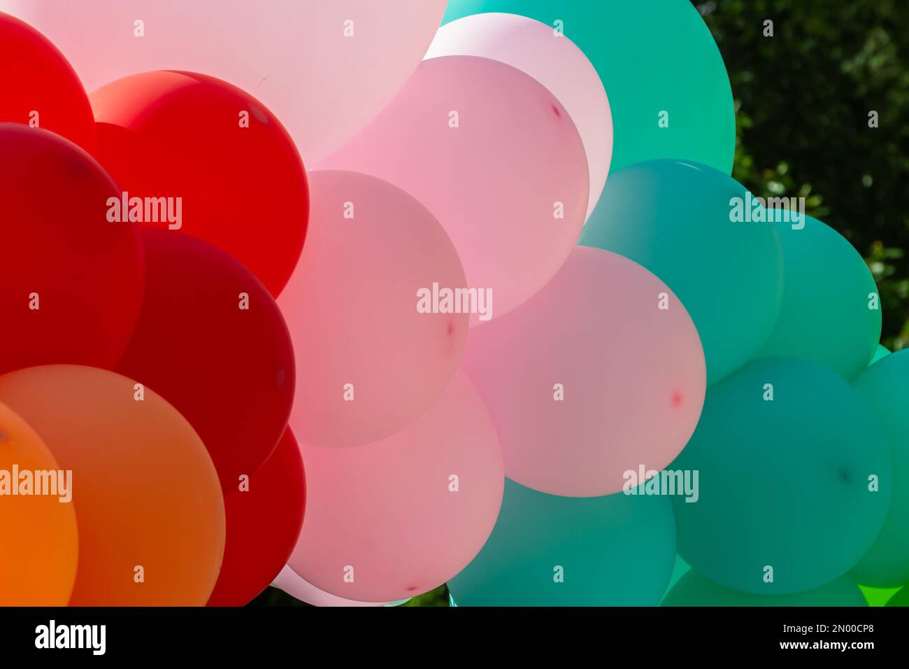 Bright abstract background of jumble of rainbow colored balloons ...