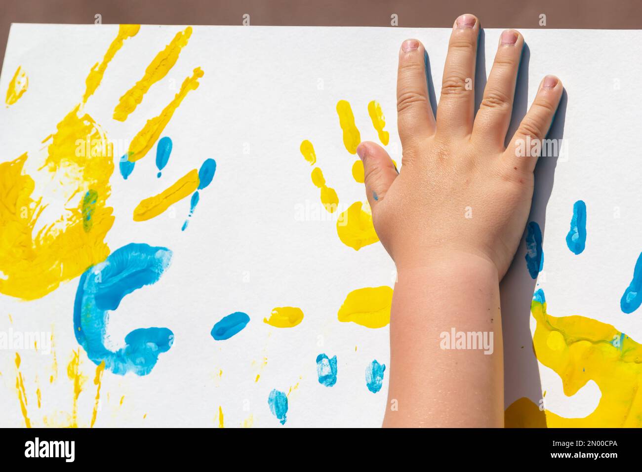 bright prints of children's hands from paint on the wall, background ...