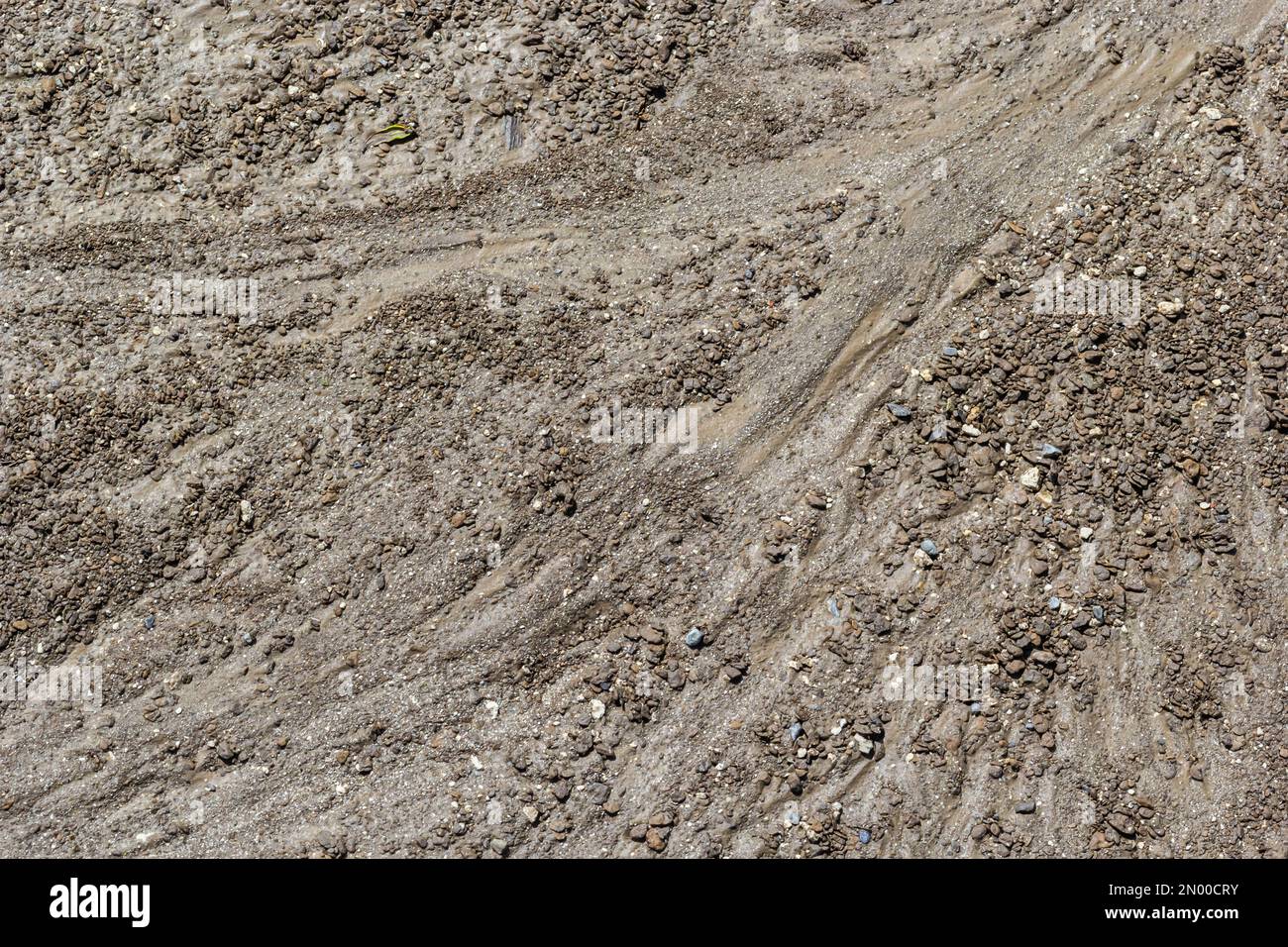 Dirty washed dirt road with traces of water flow in spring. Off-road ...