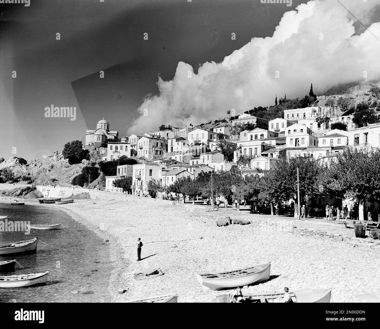 The beach and village of San Kirikos on the island of Ikaria, Greece ...