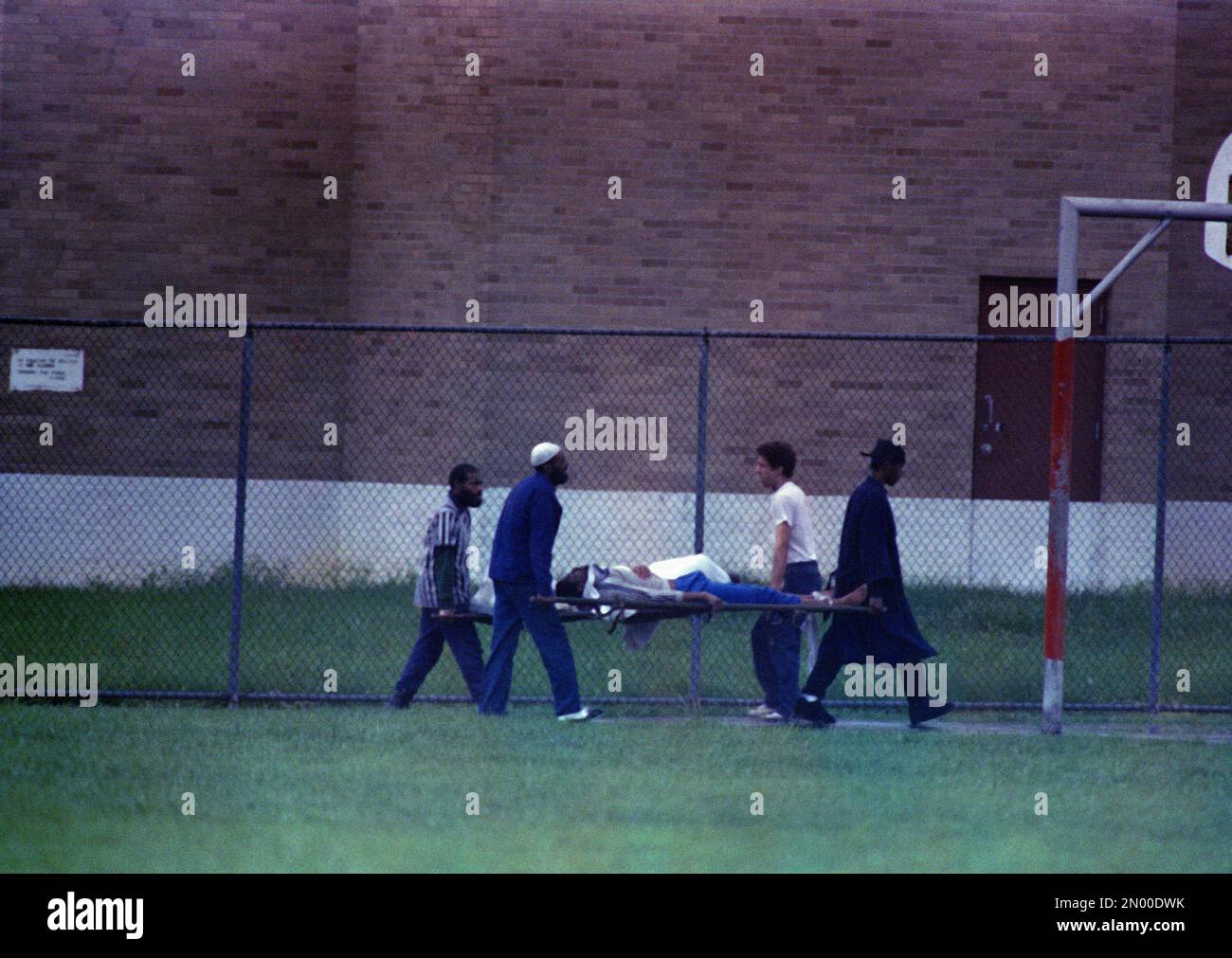 Inmates carry inmates on stretchers from the cell block of the Southern ...