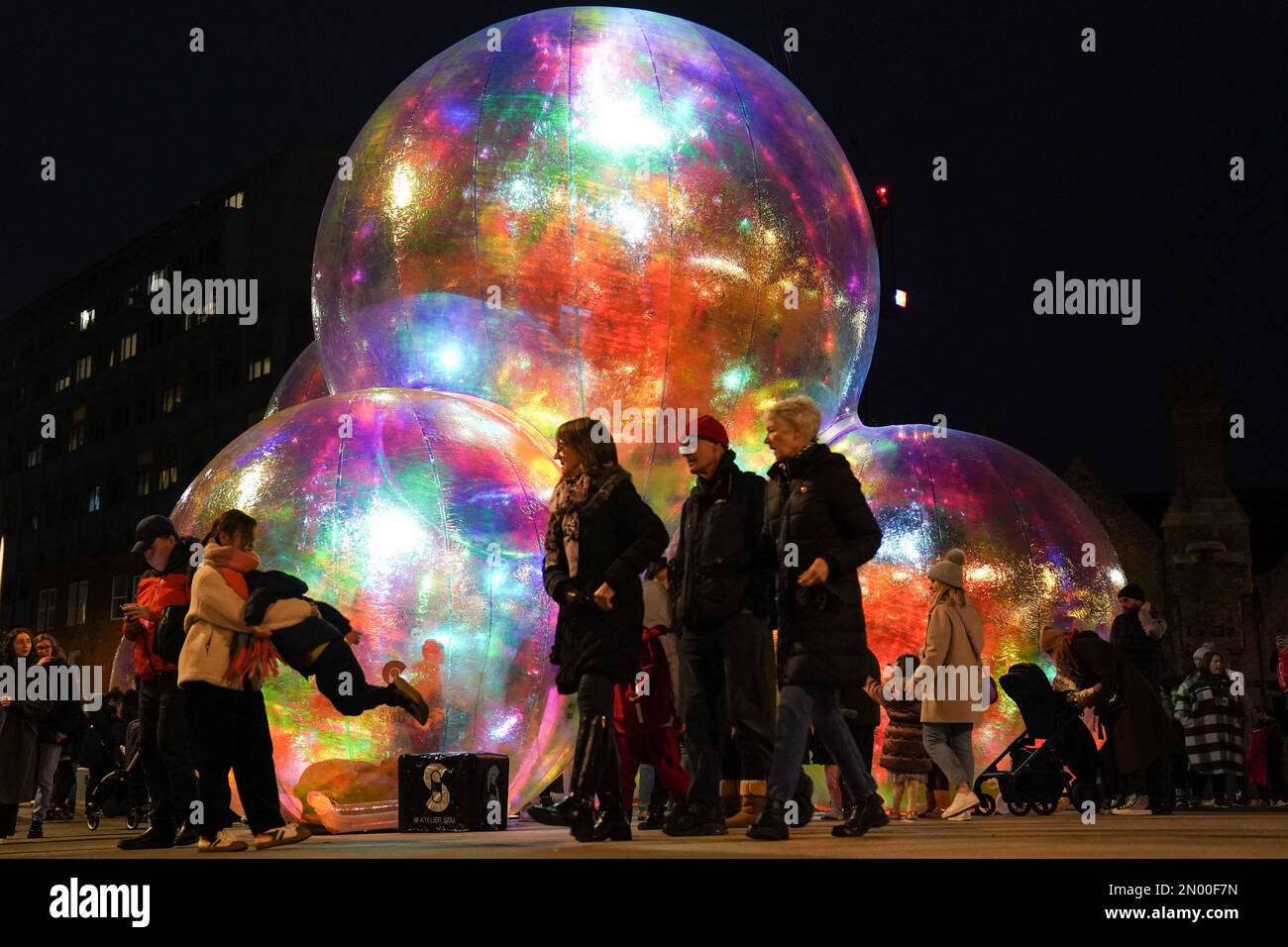 Visitors observe Evanescent, an immersive light and sound installation ...