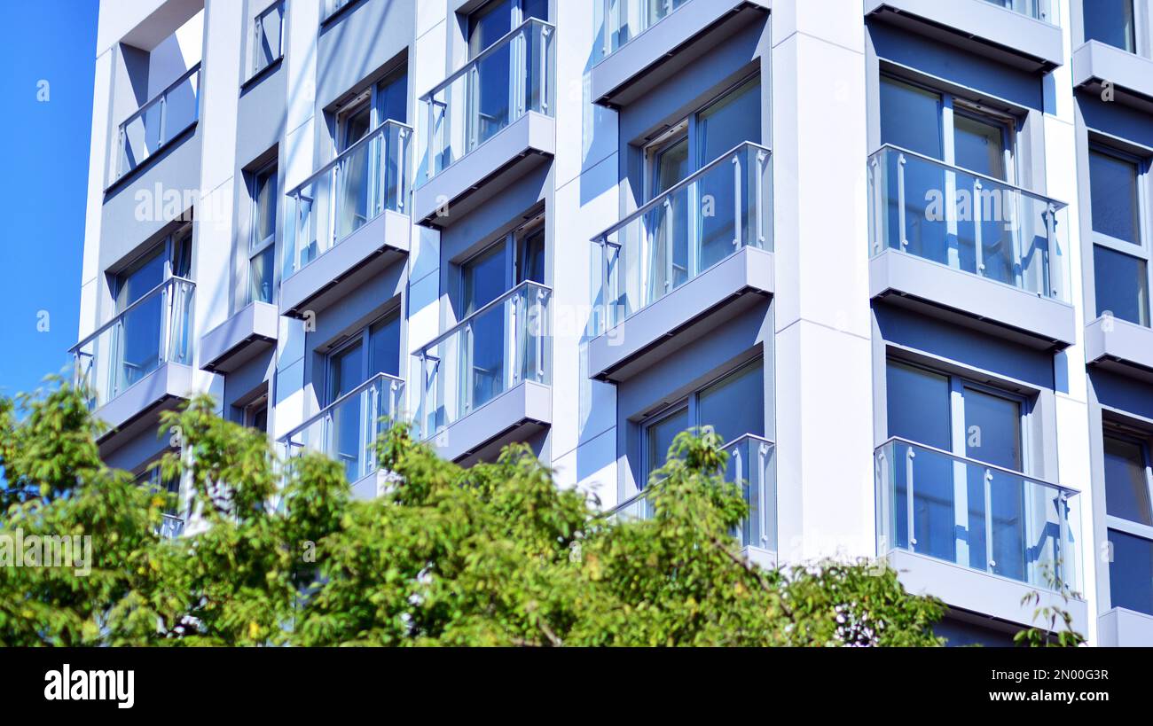 Eco architecture. Green tree and apartment building. The harmony of ...