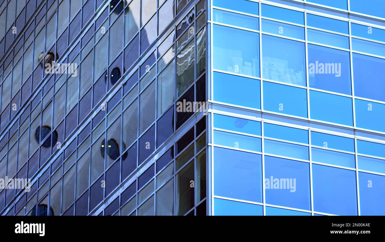 Glass building with transparent facade of the building and blue sky ...