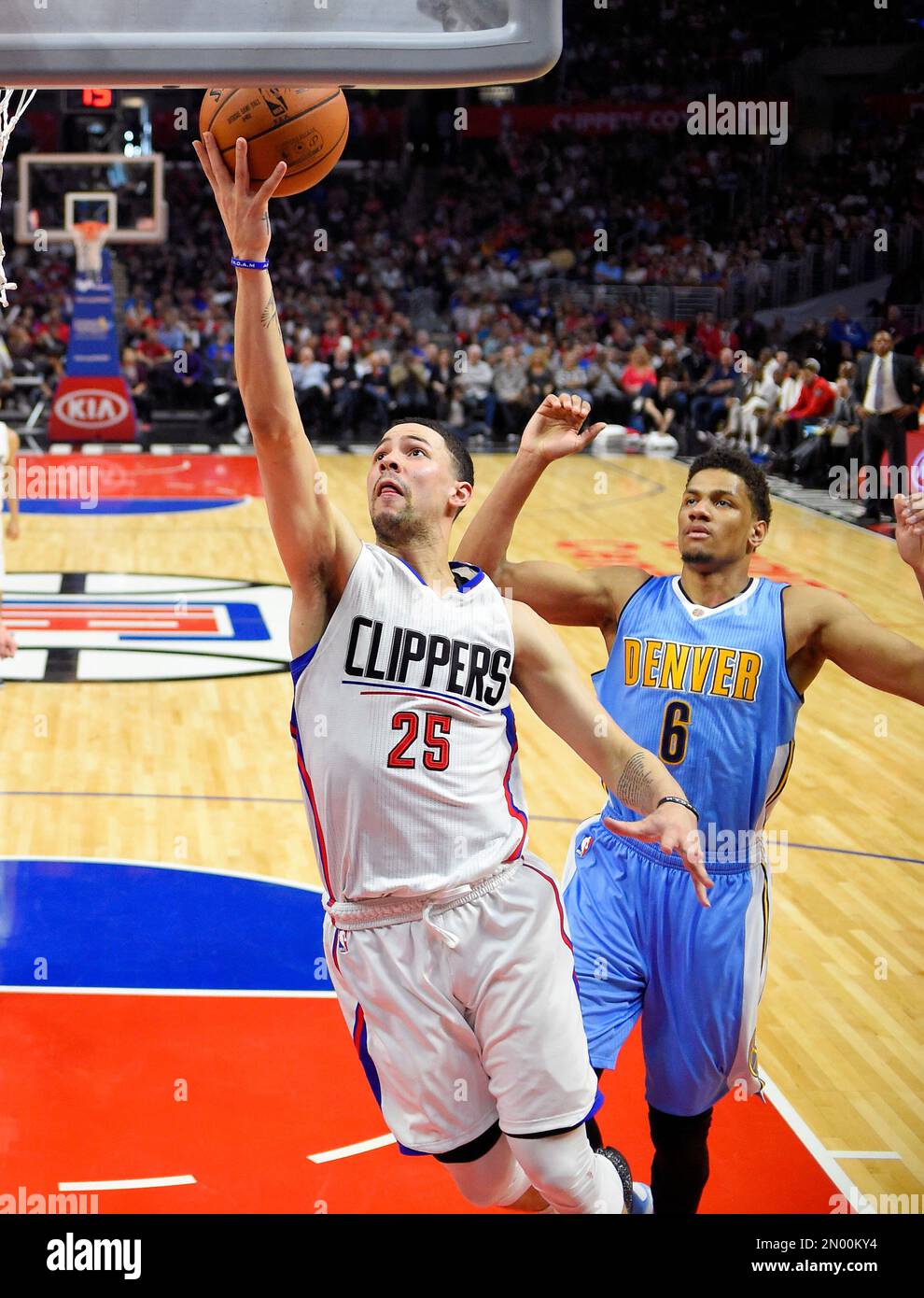 Los Angeles Clippers guard Austin Rivers, left, shoots as Denver ...