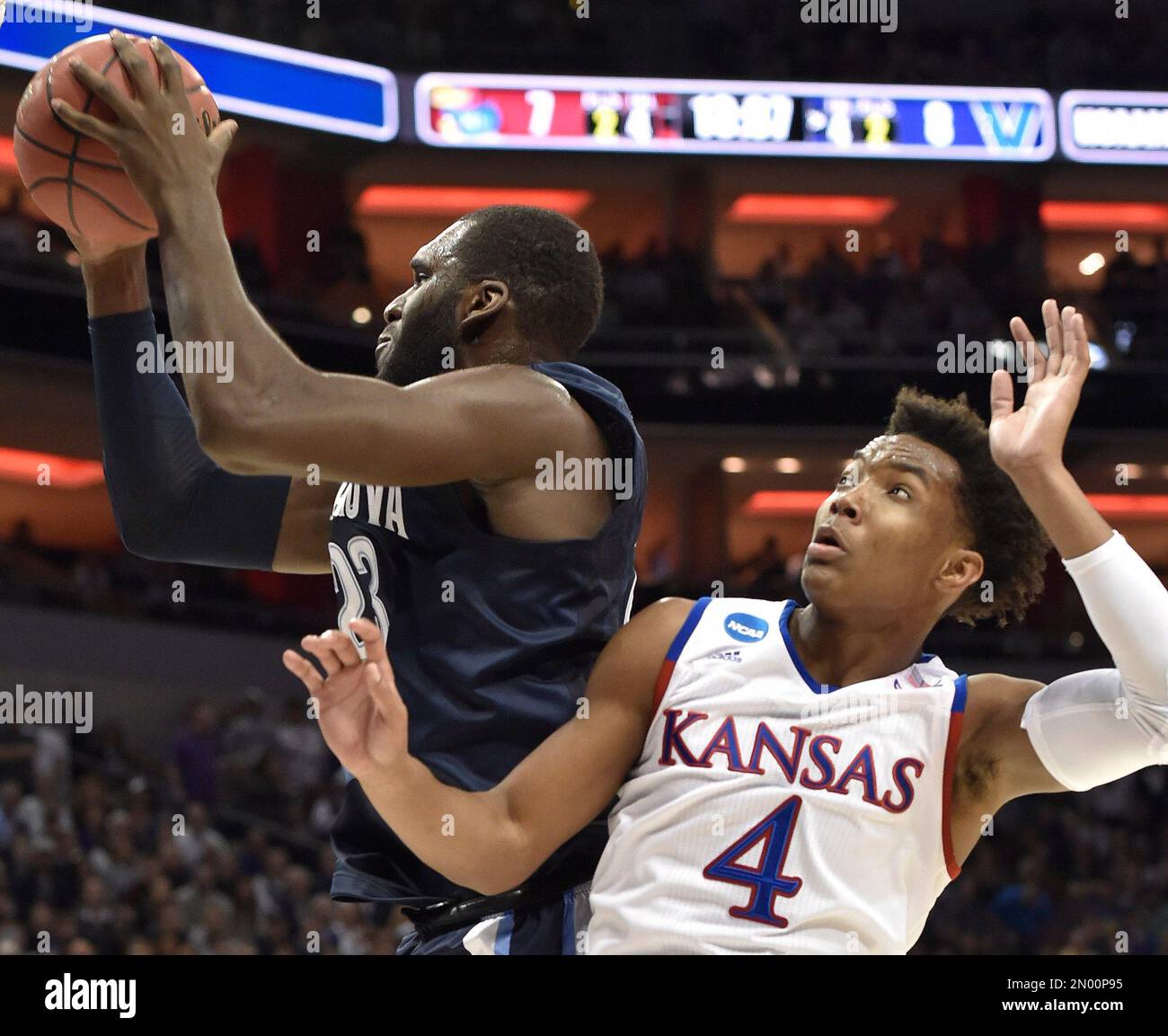 Villanova forward Daniel Ochefu (23) moves by Kansas guard Devonte ...