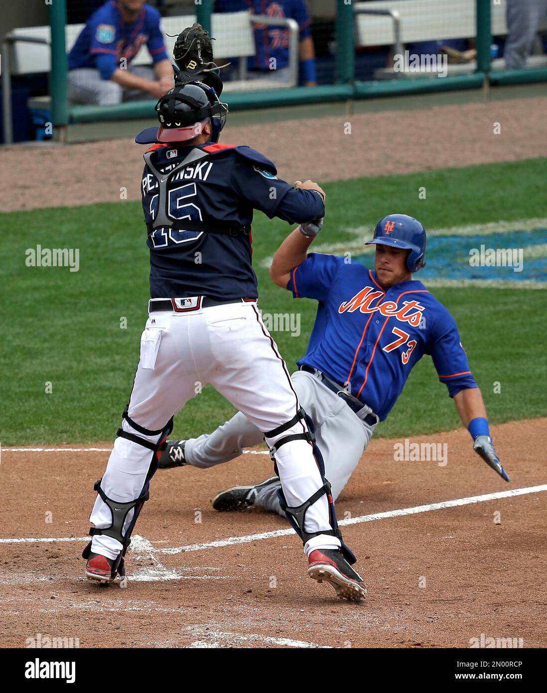 New York Mets' Travis Taijeron (73) slides home safe ahead of the tag ...