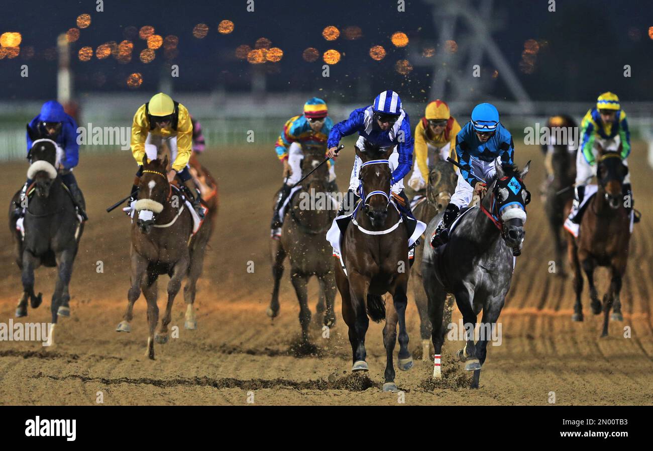 UAE horse Muarrab ridden by Paul Hanagan, centre, crosses the finish ...