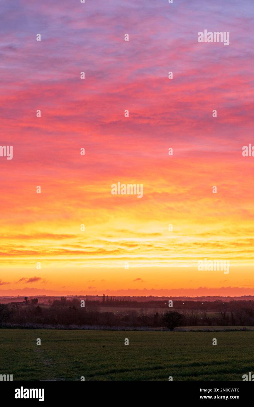 A beautiful dawn sky turning from purple clouds at the top to yellow on ...