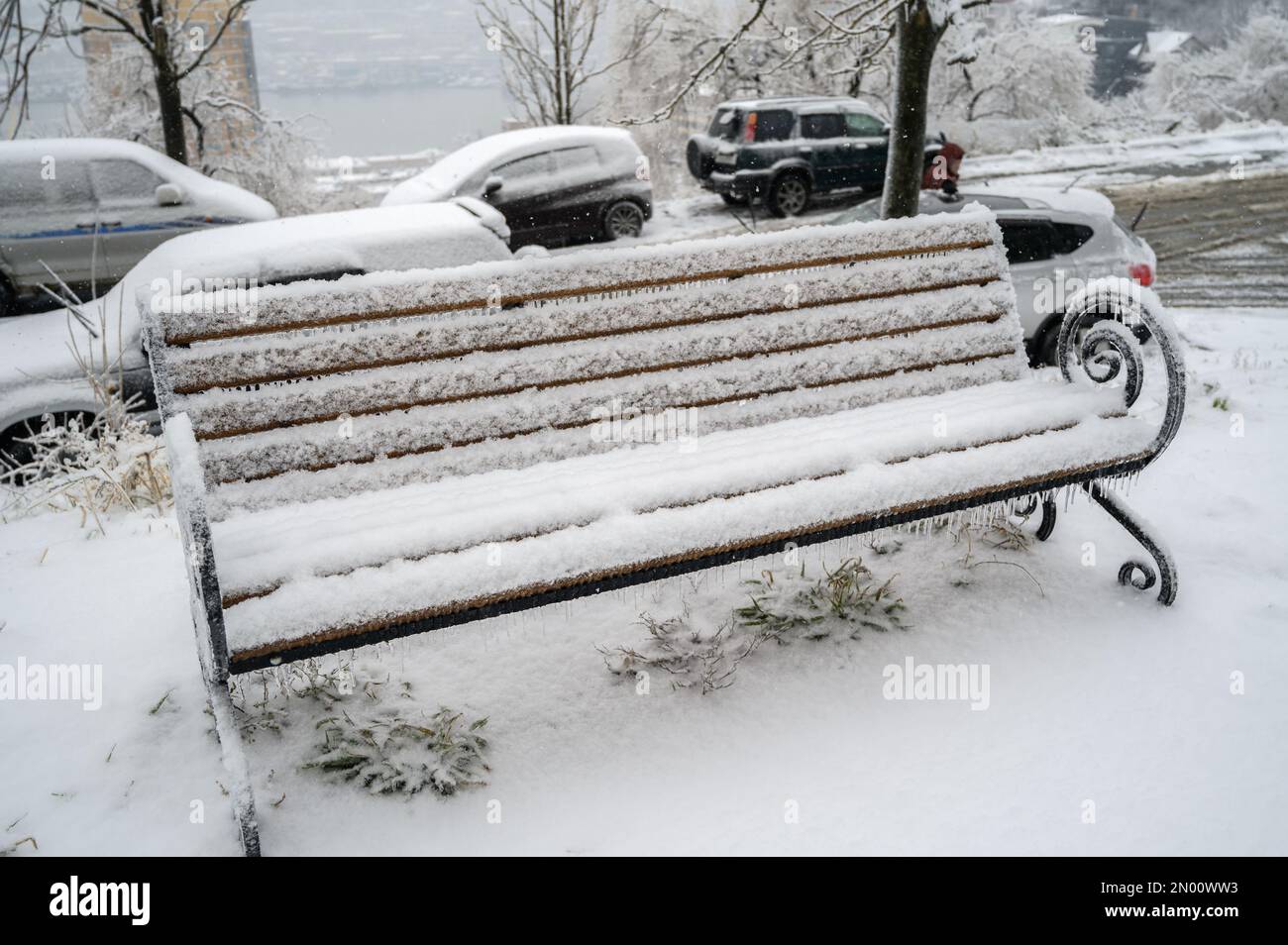 Bench covered with snow and ice in winter Stock Photo - Alamy