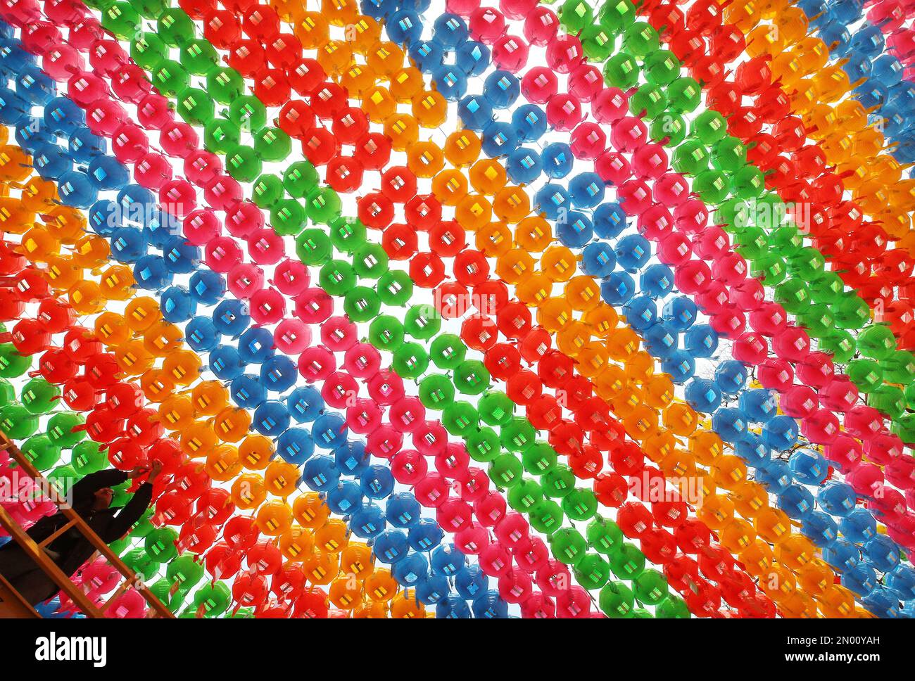 A worker attaches the name tag of a Buddhist who made donation to a ...