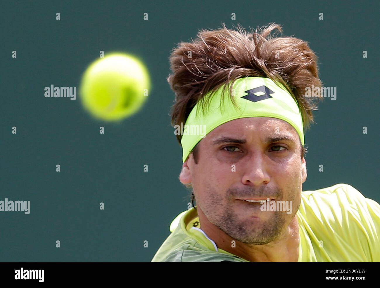 David Ferrer, of Spain, keeps his eyes on the ball as he gets set to ...