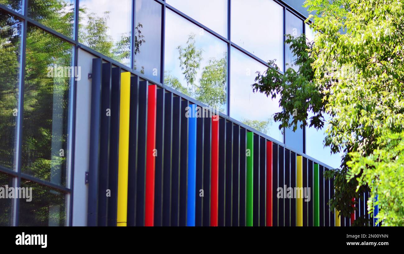 Eco architecture. Green tree and glass office building. The harmony of ...