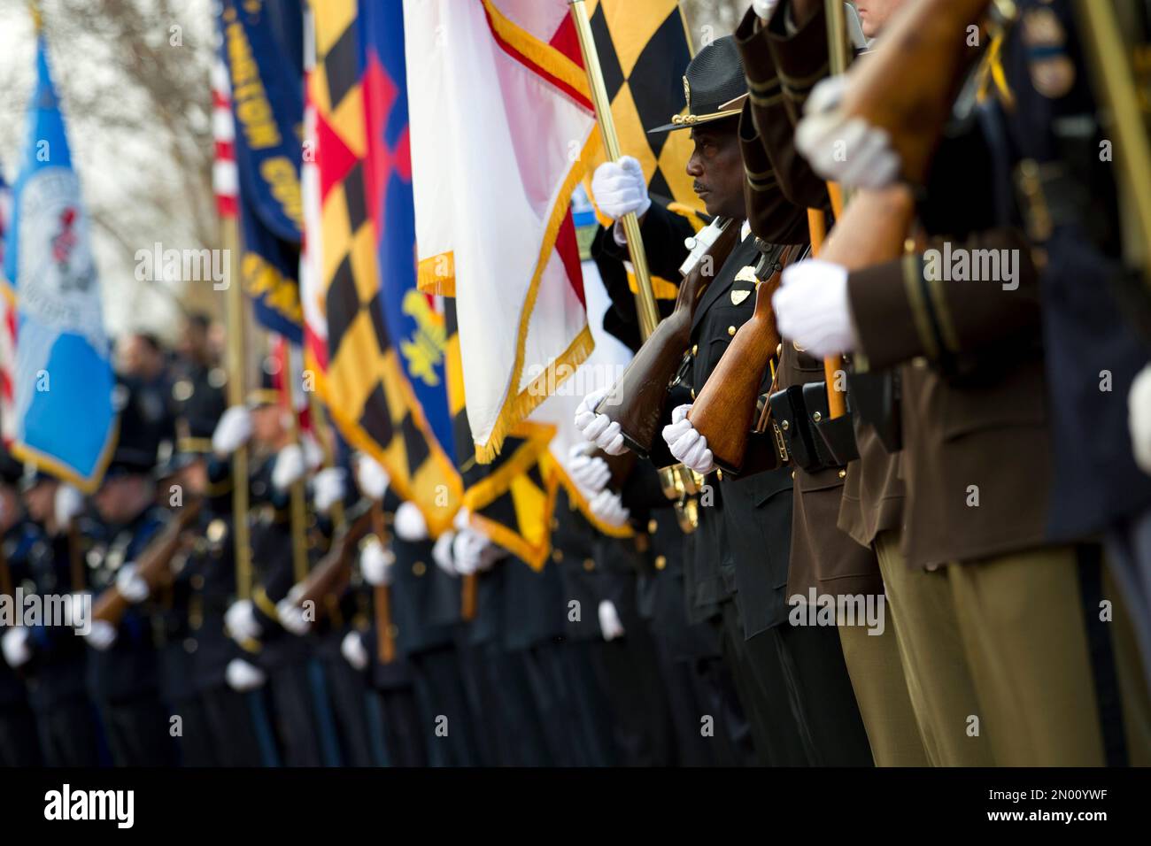 Maryland police stand at attention upon the arrival of the hearse ...
