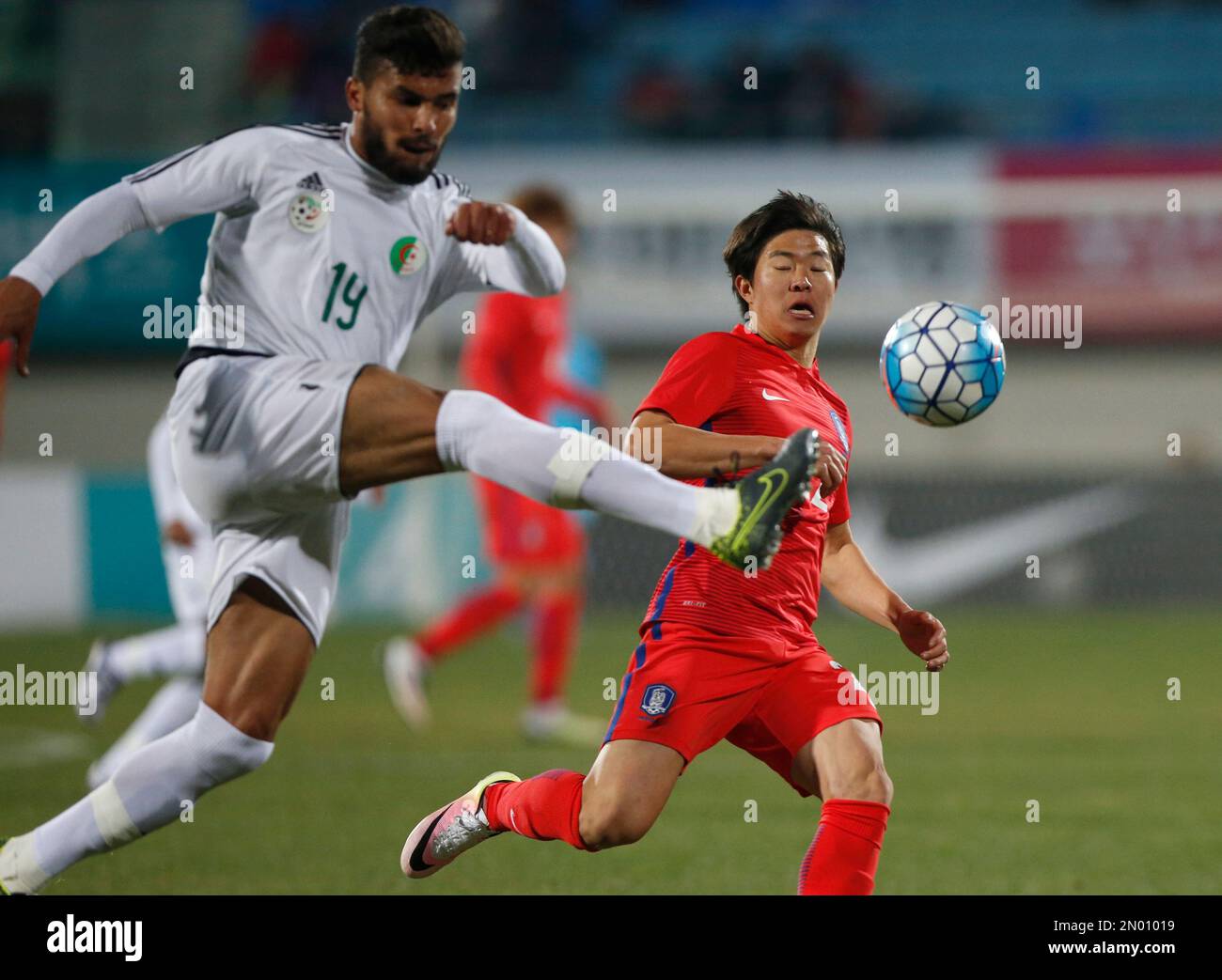 Algeria's Houcine Benayada, left, fights for the ball against South ...