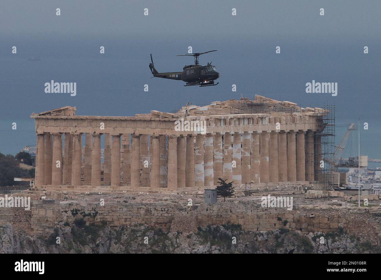 A Military helicopter flies over the Parthenon temple on the ancient ...