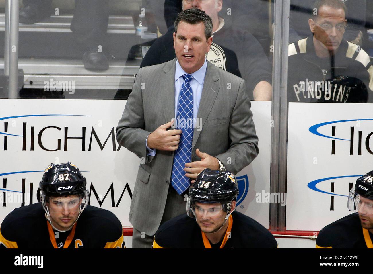 Pittsburgh Penguins head coach Mike Sullivan stands behind his bench ...