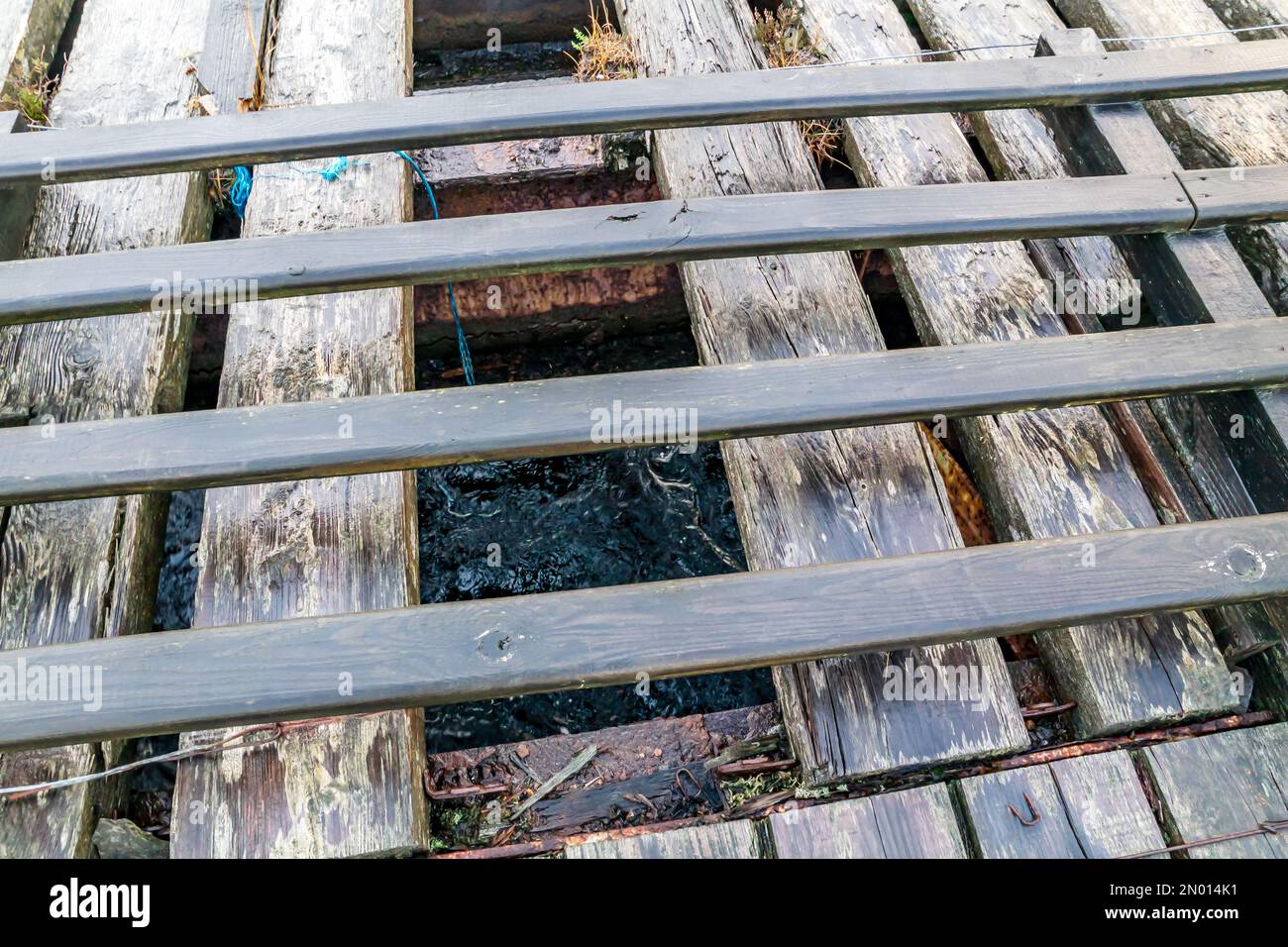 An old, rotten wooden bridge over the Owenea river by Ardara in County ...