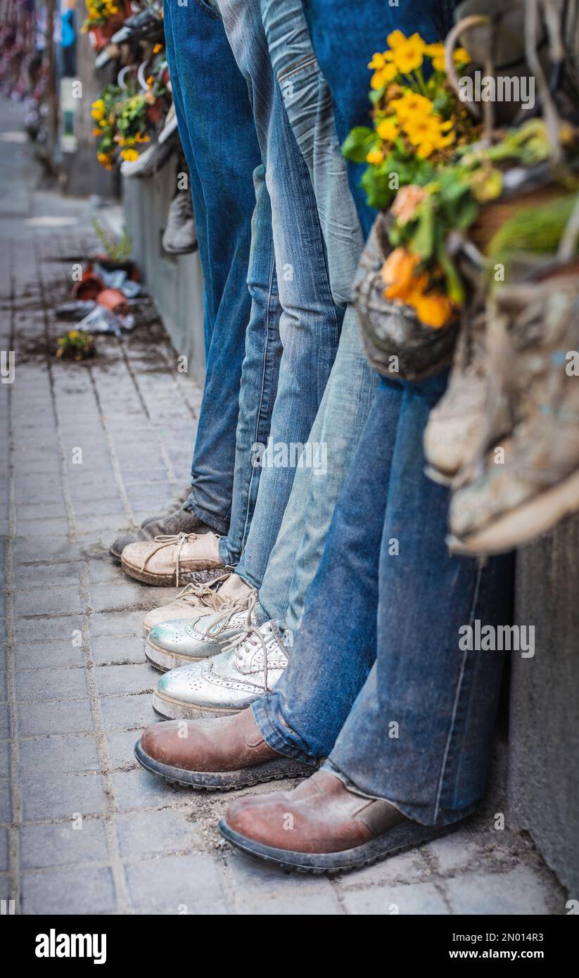 side view of jeans in a row on a sidewalk. vertical format Stock Photo ...
