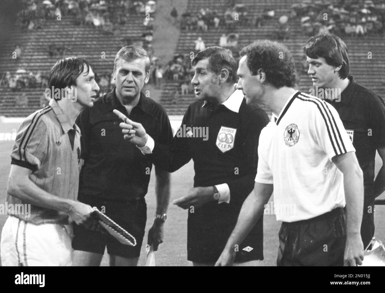 Dutch captain Johan Cruyff, left, talks with the referee, watched by ...