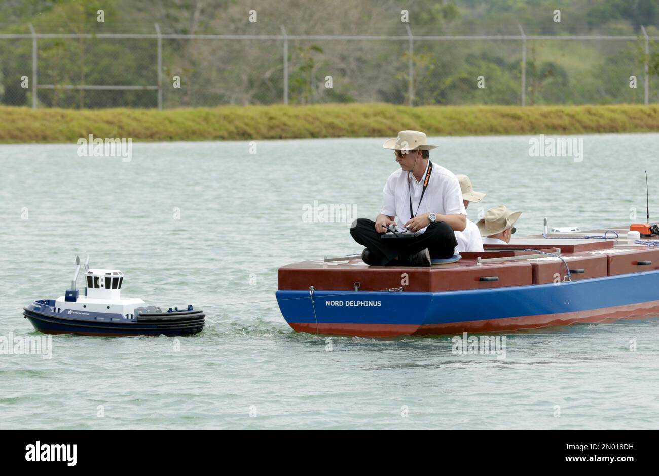 A Panama Canal pilot sails a miniature ship during the inauguration of ...