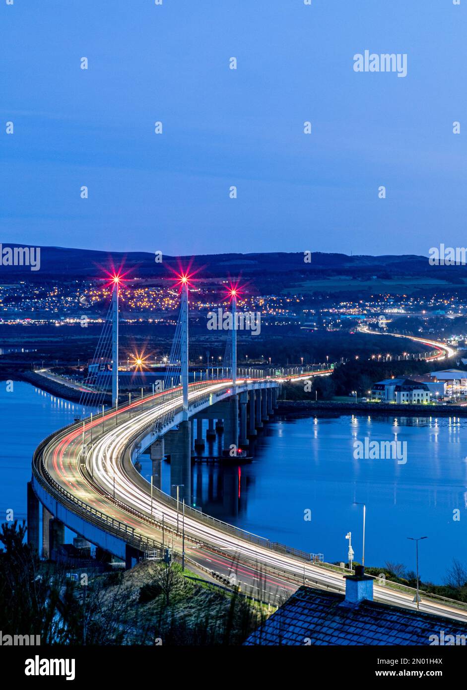 A drone shot of the traffic light trails over Kessock Bridge after dark ...