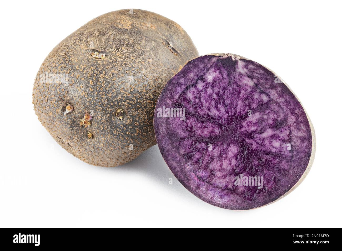 Vitelotte potatoes. Raw unpeeled purple potatoes isolated on white ...