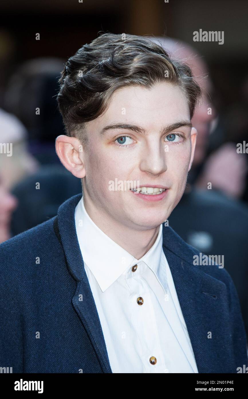 Bill Milner poses for photographers upon arrival at the Empire Film ...