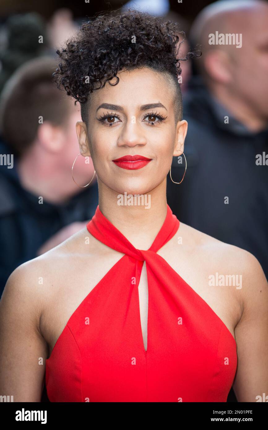 Dominique Tipper poses for photographers upon arrival at the Empire ...