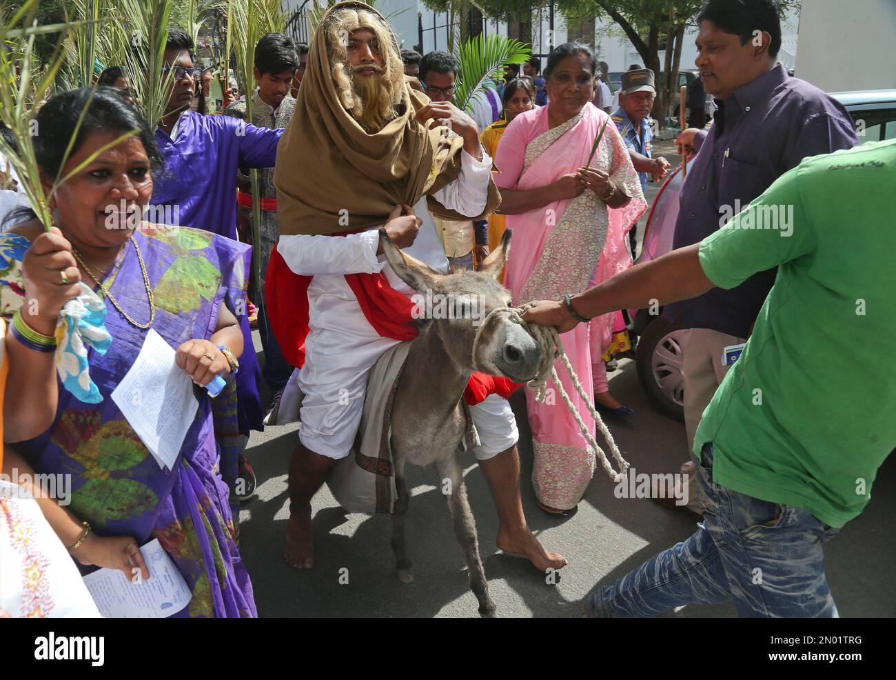 An Indian Christian devotee dressed like Jesus Christ sits on a donkey ...