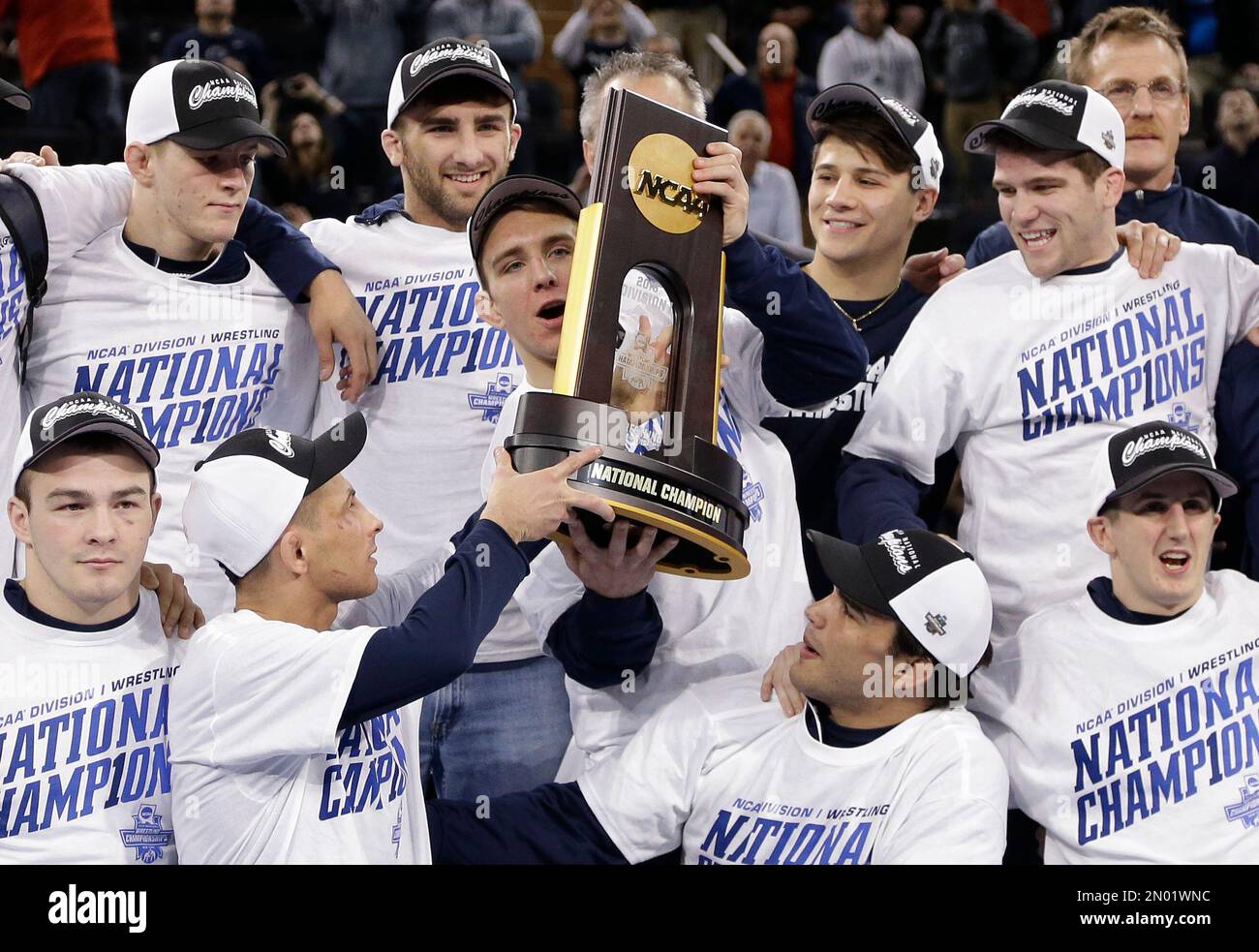 Penn State's Zain Retherford, center, is handed the team's trophy as ...