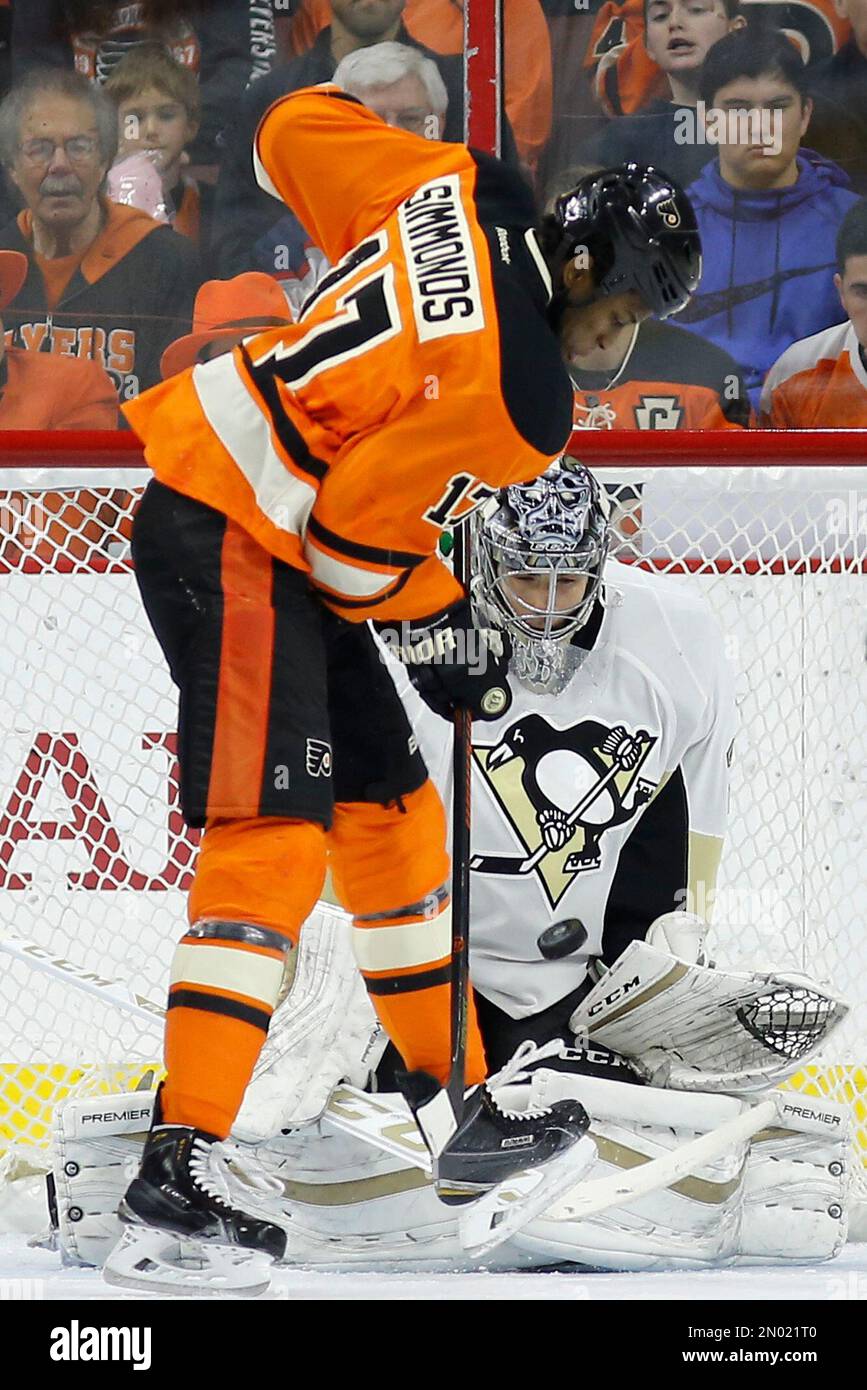 Pittsburgh Penguins' Marc-Andre Fleury, right, blocks a shot as ...