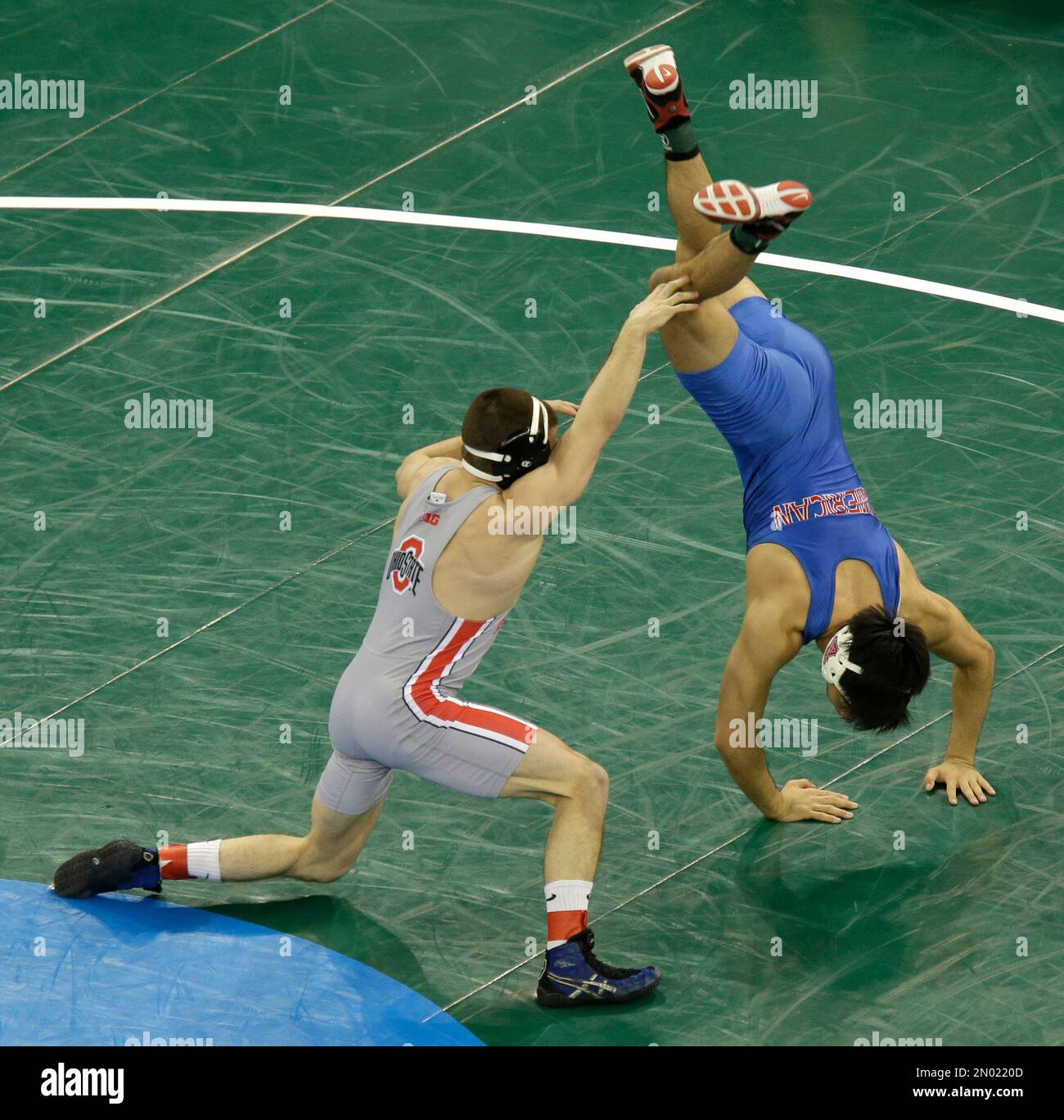 American University's David Terao, right, cartwheels away from Ohio ...