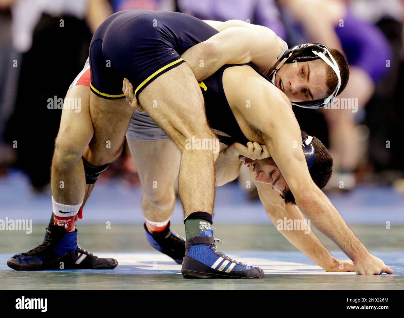 Ohio State's Nathan Tomasello, top, grapples with Michigan's Conor ...