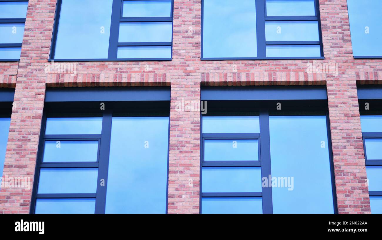Modern brick and glass facade of the office building. A contrasting ...